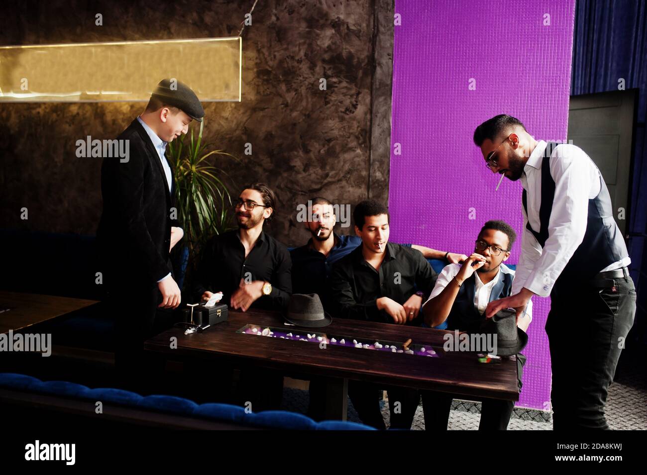 Group of handsome retro well-dressed man gangsters spend time at club ...