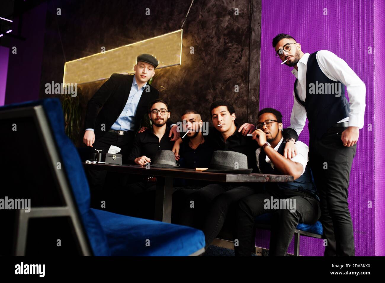 Group of handsome retro well-dressed man gangsters spend time at club ...