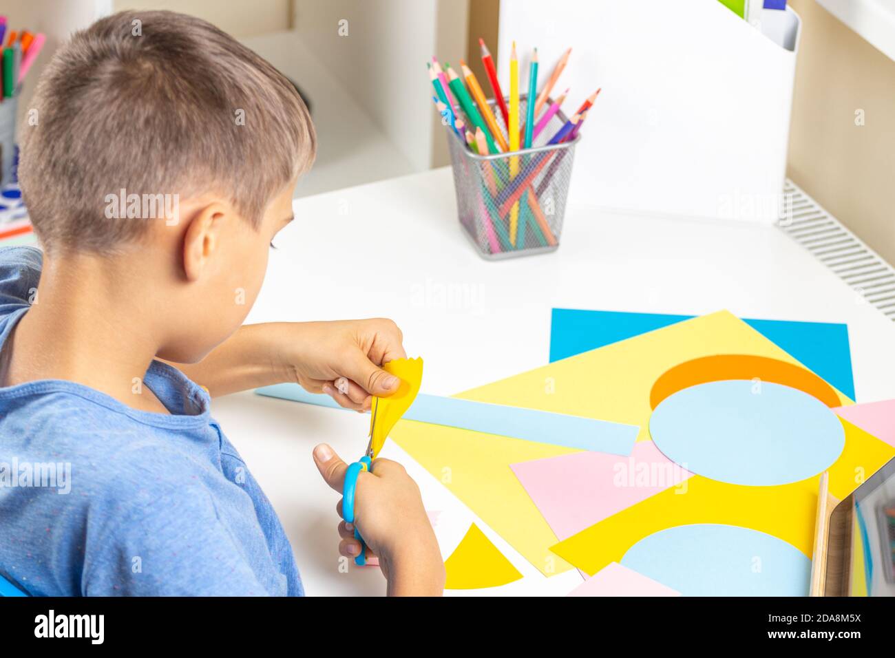 Kid hands cutting colored paper with scissors. Education, learning ...