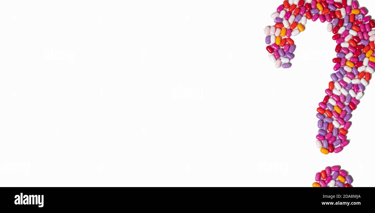 question mark of colored pills on a white background. colored pills ...