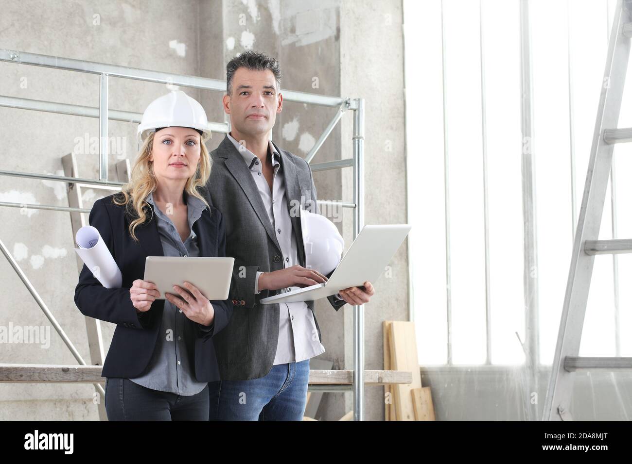 man and woman architects or engineers with computer work together in ...