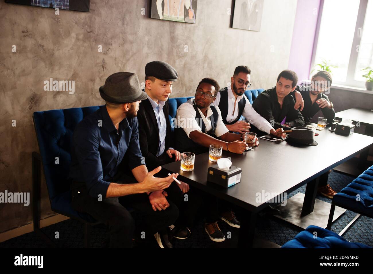 Group of handsome retro well-dressed man gangsters spend time at club ...