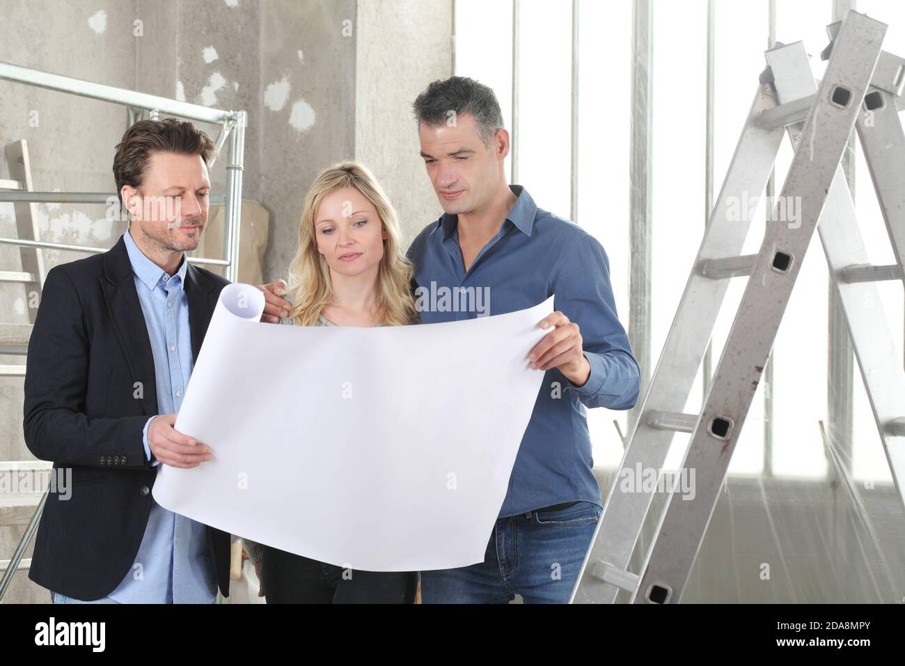 Architect showing house design plans to a young couple. House building ...