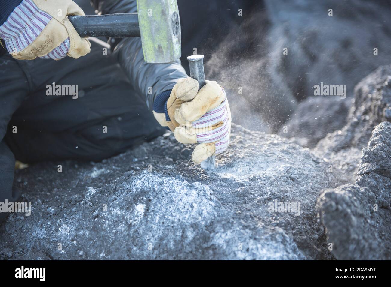 Scientists collect rock samples on the slopes of Mount Erebus ...
