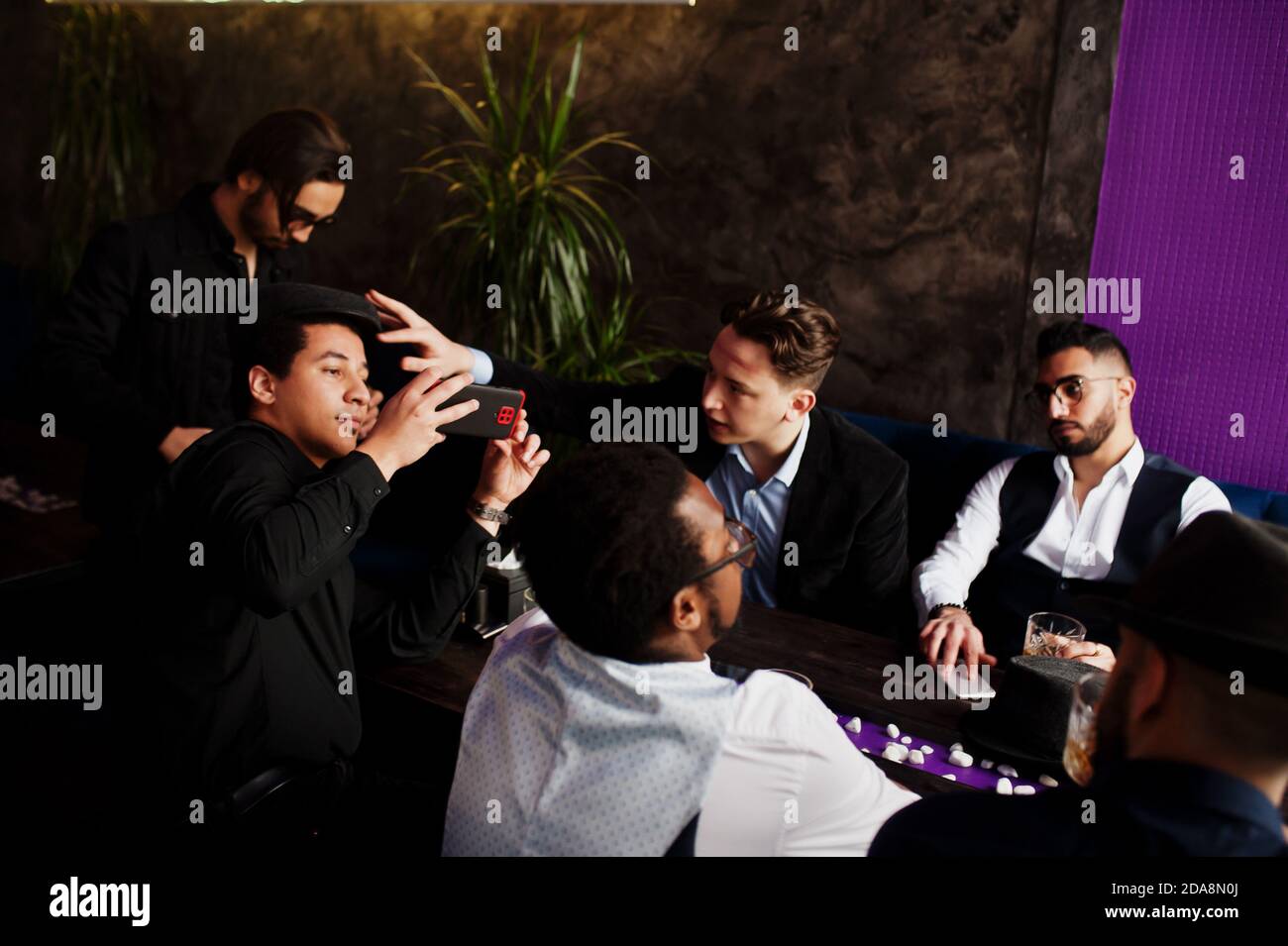 Group of handsome retro well-dressed man gangsters spend time at club ...