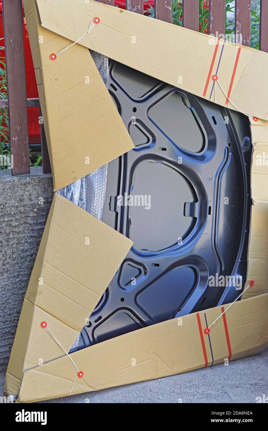 New hood car part deliver in cardboard box package Stock Photo - Alamy