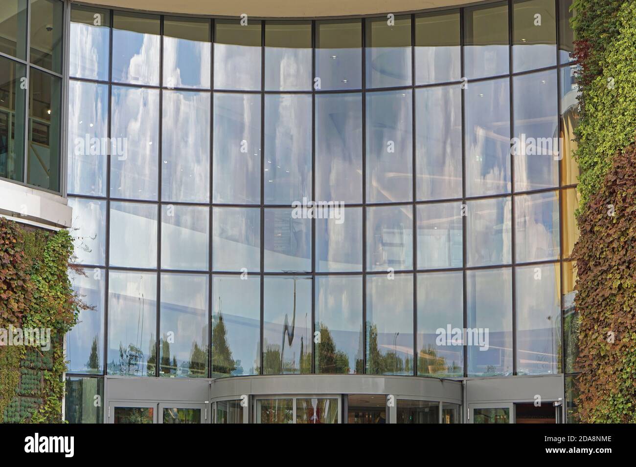 Big wall covered with many glass windows exterior Stock Photo - Alamy