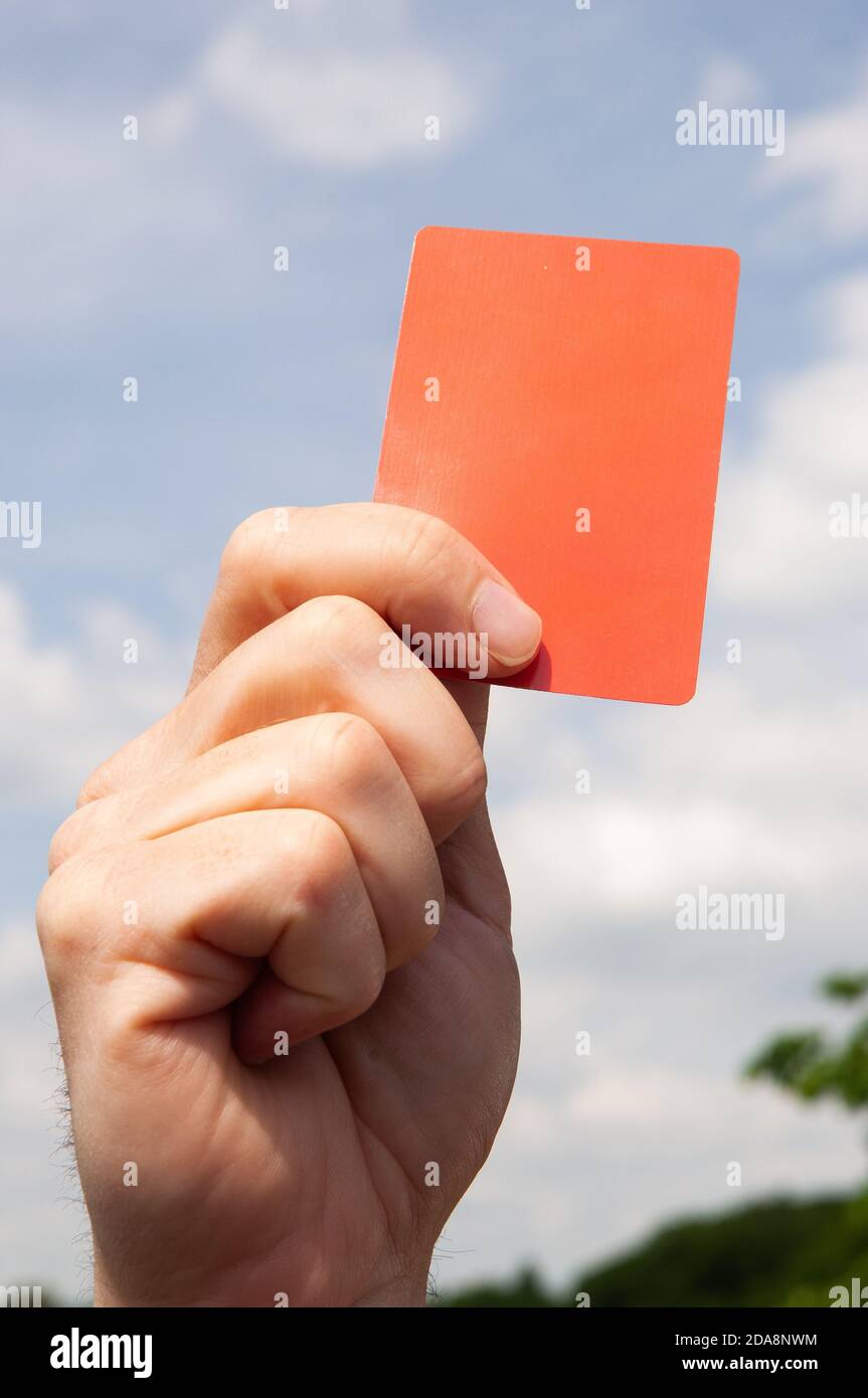 A hand holding up a Red Card Stock Photo - Alamy