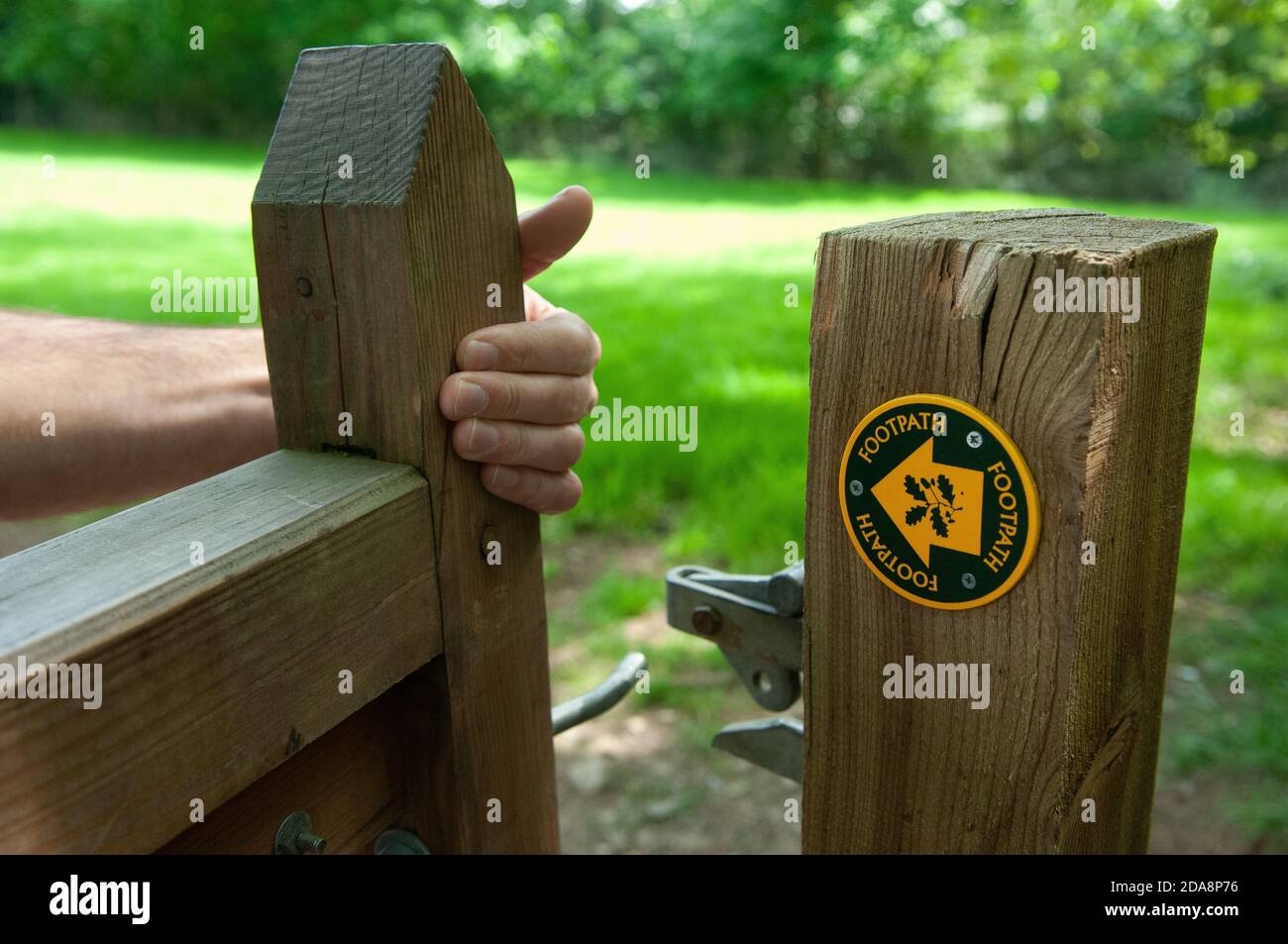 Hands opening a footpath gate Stock Photo - Alamy
