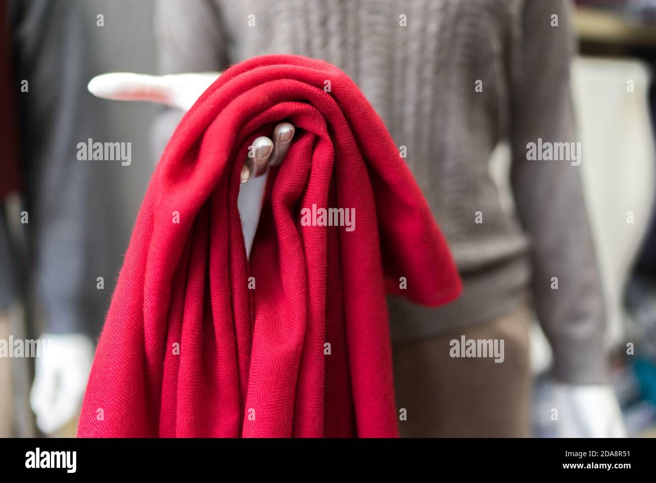 clothes in a shop, red cashmere scarf in a showroom, clothing store ...