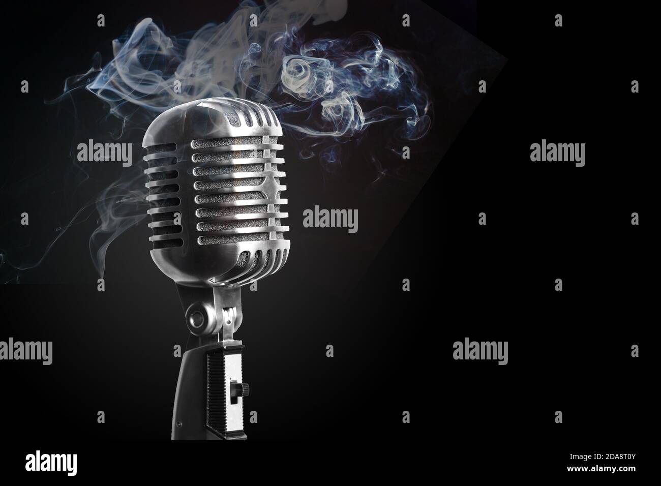 A microphone has smoke around it on black background for a music or ...
