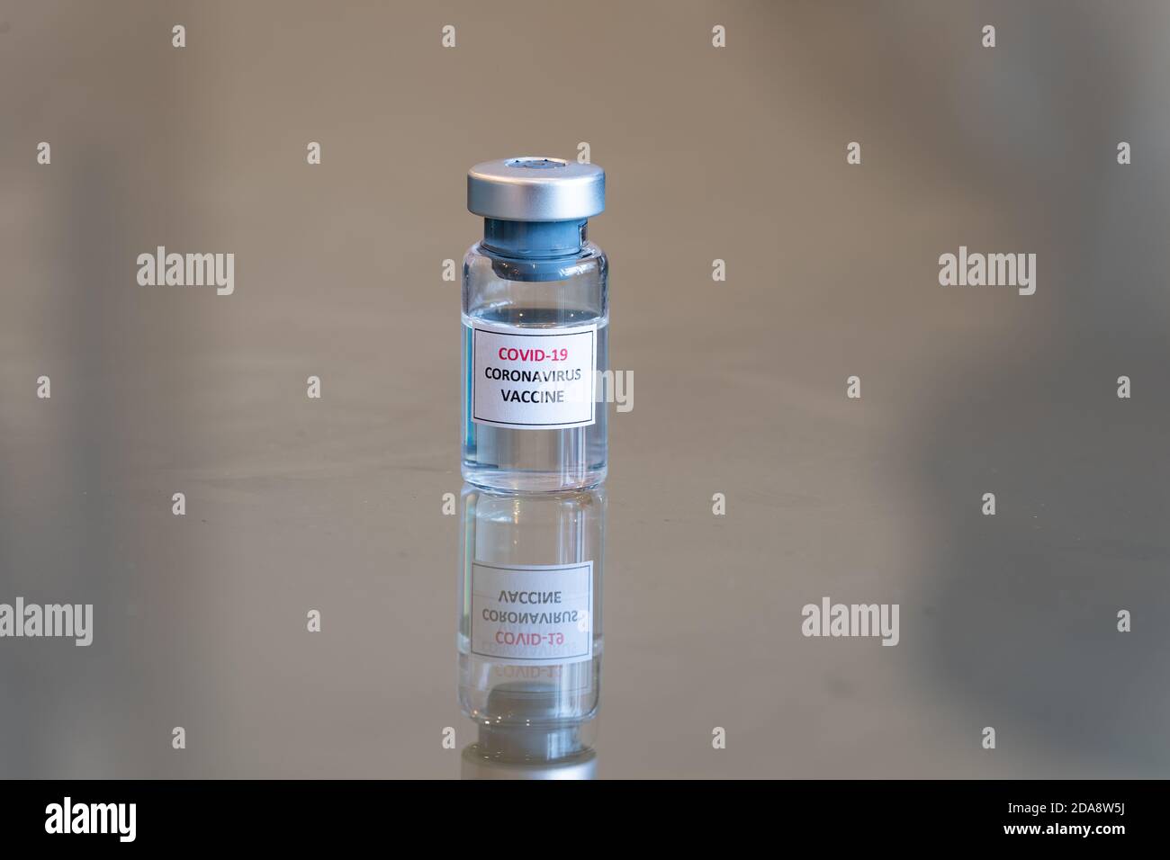 Closeup view of a medical vial labelled as a COVID-19 Coronavirus ...