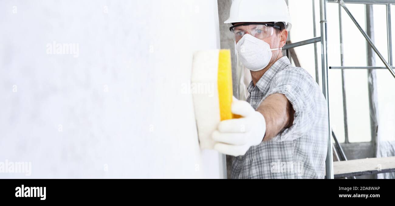 man builder using a sponge on wall professional construction worker ...