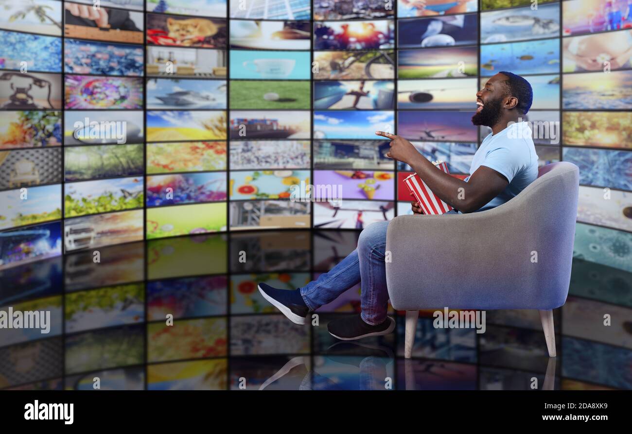 Man has fun watching a film. Concept of entertainment and streaming tv ...