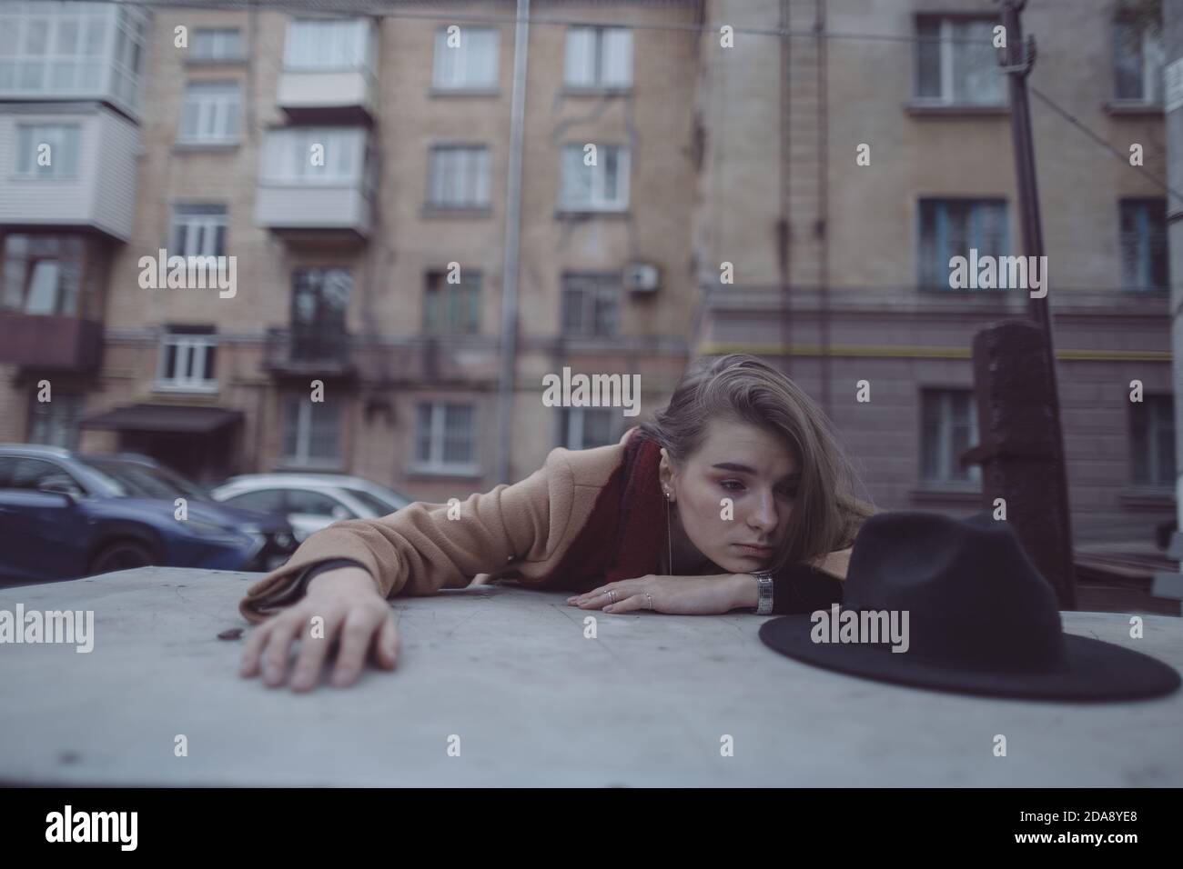 sad Ukrainian young girl sitting on a bench in the yard of his ...