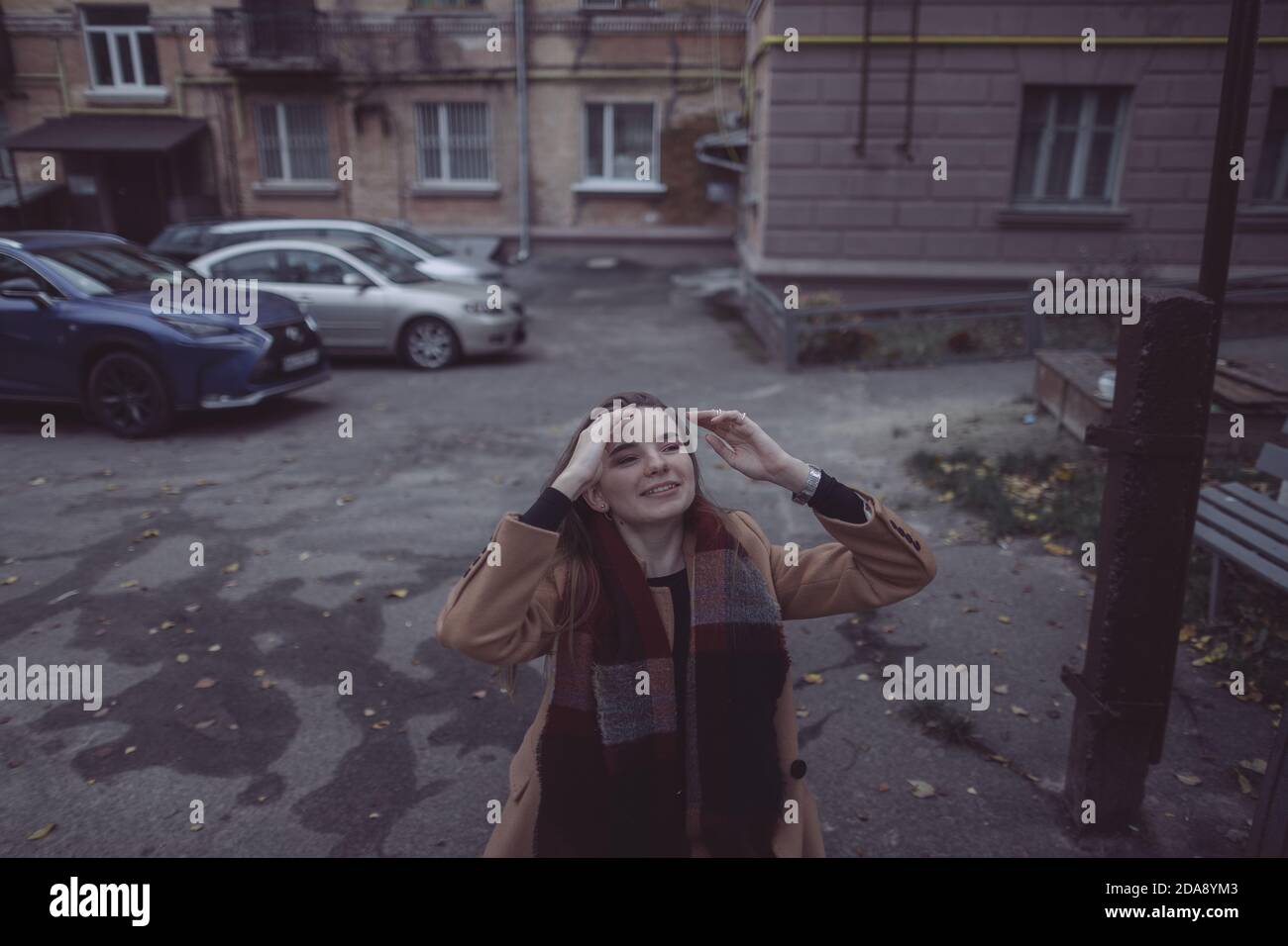 sad Ukrainian young girl sitting on a bench in the yard of his ...
