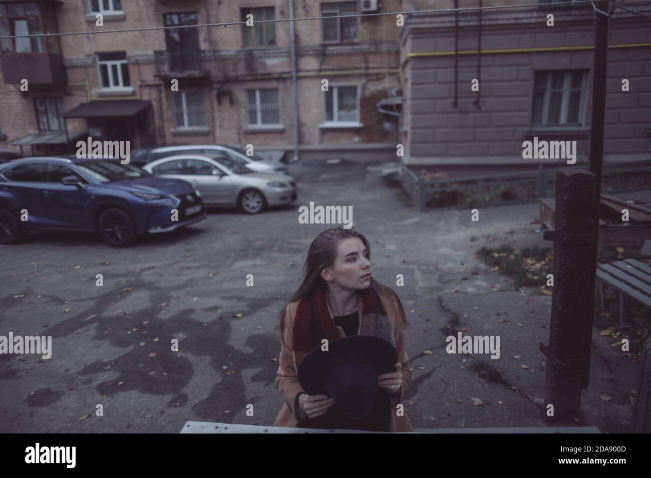 sad Ukrainian young girl sitting on a bench in the yard of his ...