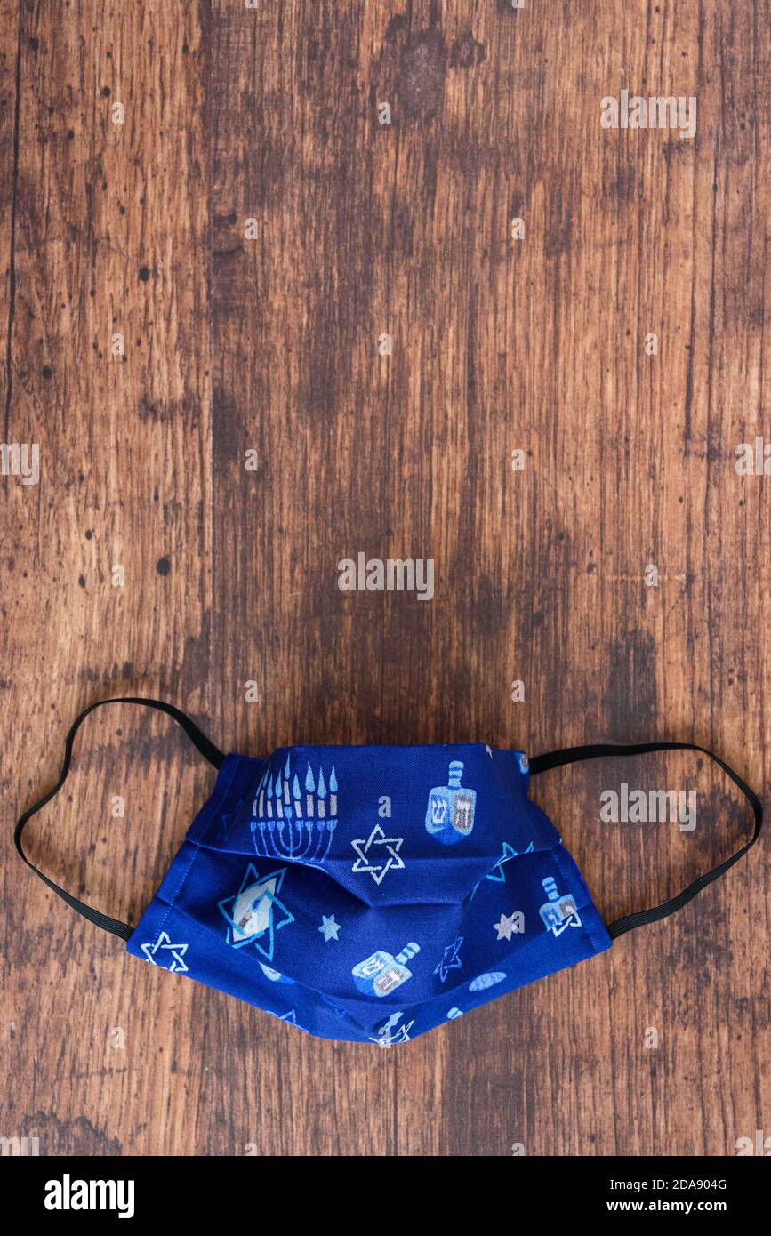 Hand made fabric masks on a wood background, celebrate Hanukkah with ...