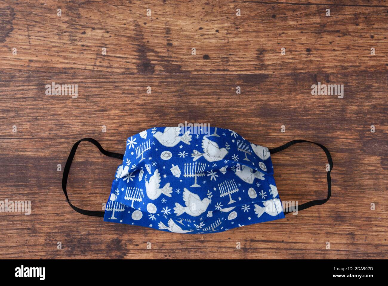 Hand made fabric masks on a wood background, celebrate Hanukkah with ...