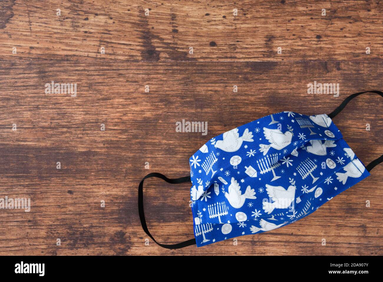 Hand made fabric masks on a wood background, celebrate Hanukkah with ...