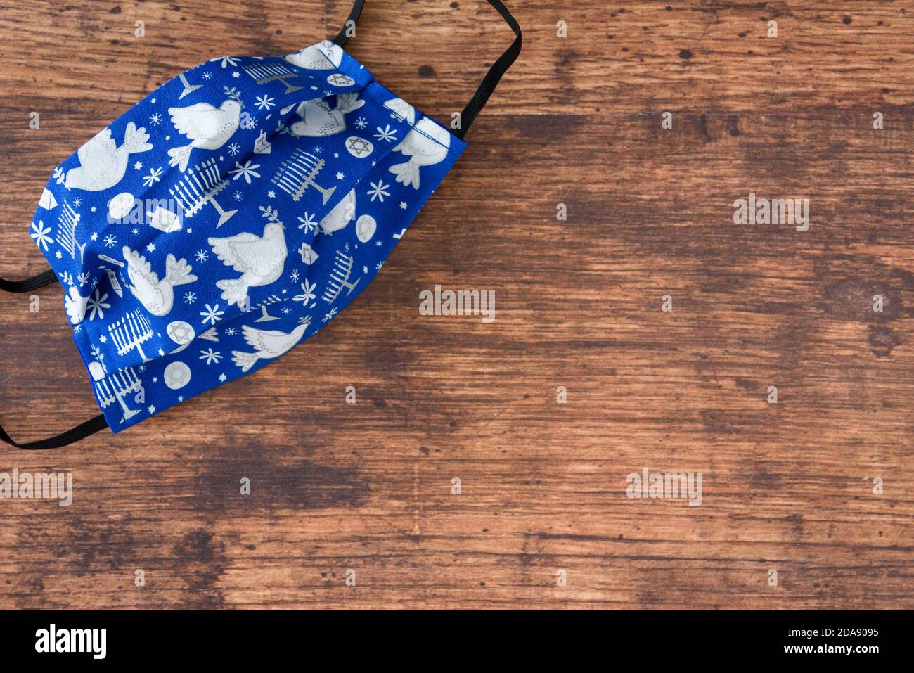 Hand made fabric masks on a wood background, celebrate Hanukkah with ...