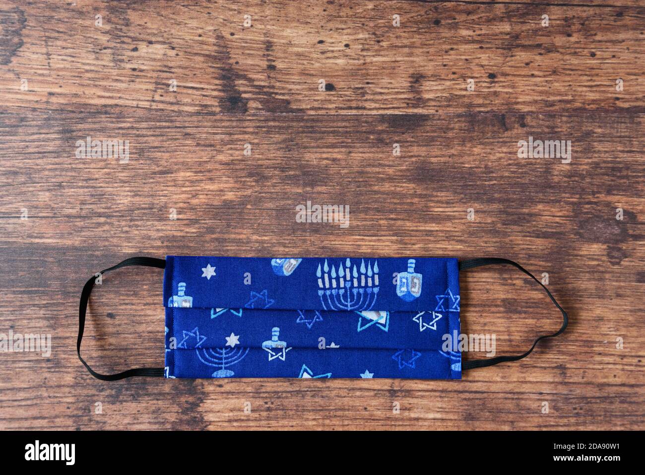 Hand made fabric masks on a wood background, celebrate Hanukkah with ...