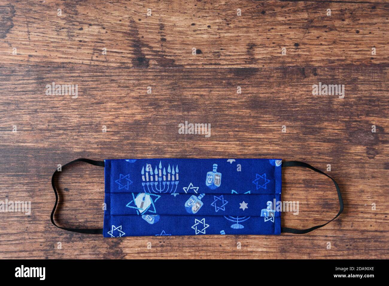 Hand made fabric masks on a wood background, celebrate Hanukkah with ...