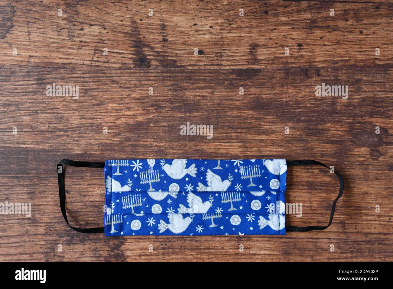 Hand made fabric masks on a wood background, celebrate Hanukkah with ...