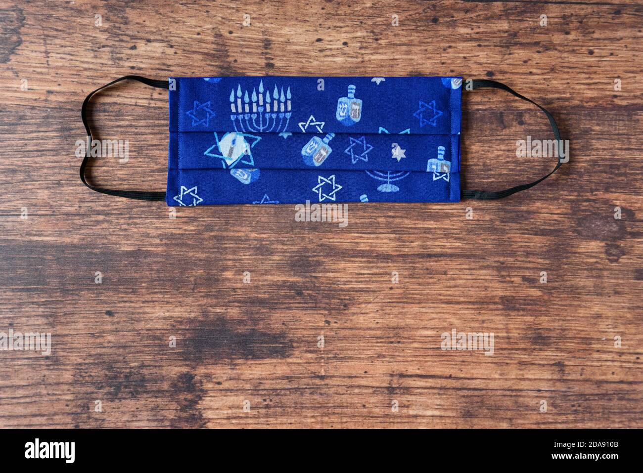 Hand made fabric masks on a wood background, celebrate Hanukkah with ...