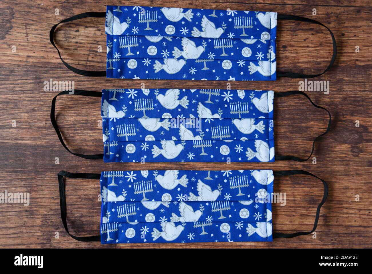 Hand made fabric masks on a wood background, celebrate Hanukkah with ...