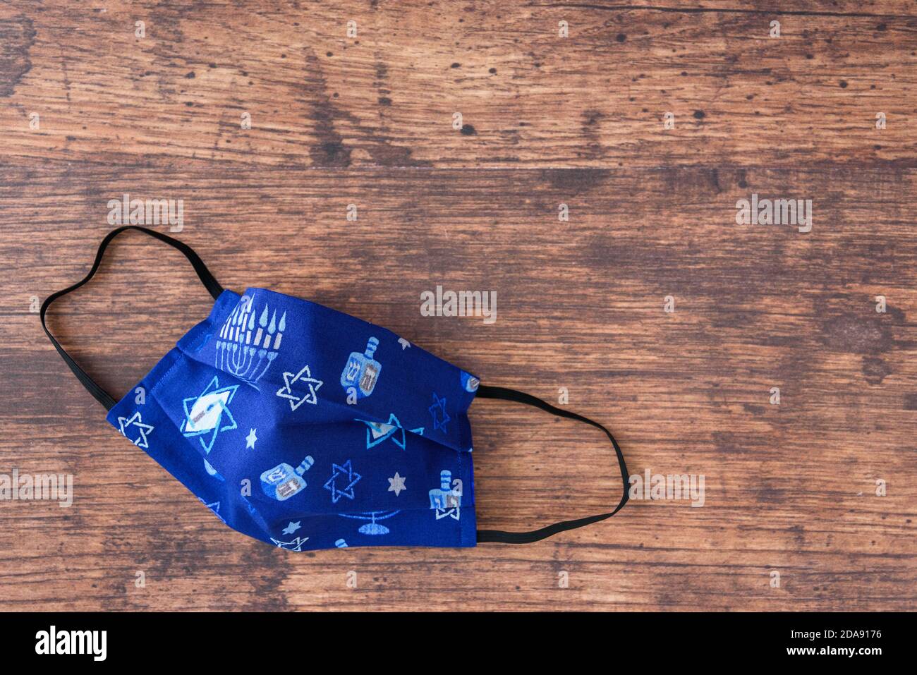 Hand made fabric masks on a wood background, celebrate Hanukkah with ...