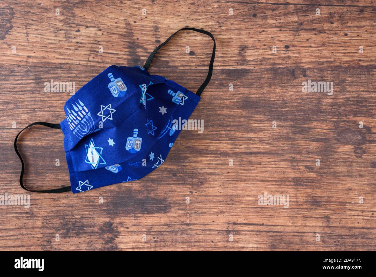 Hand made fabric masks on a wood background, celebrate Hanukkah with ...