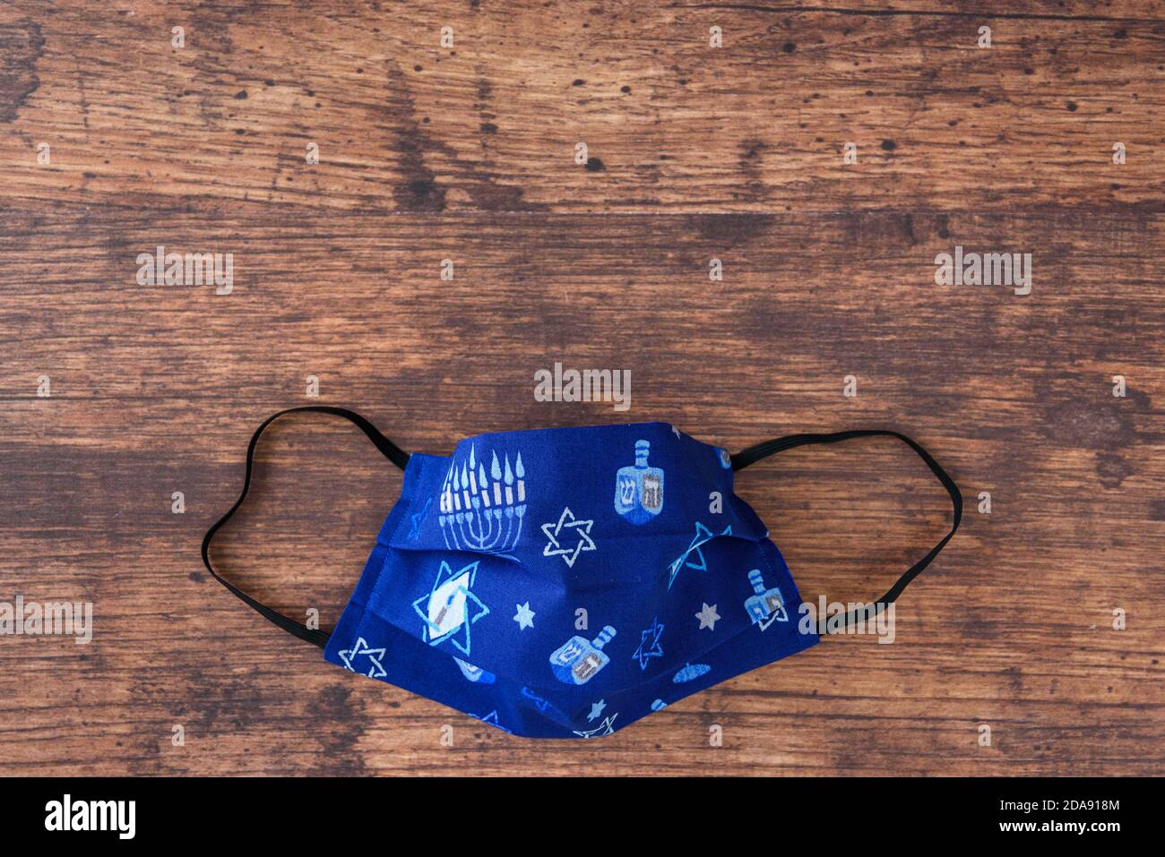 Hand made fabric masks on a wood background, celebrate Hanukkah with ...