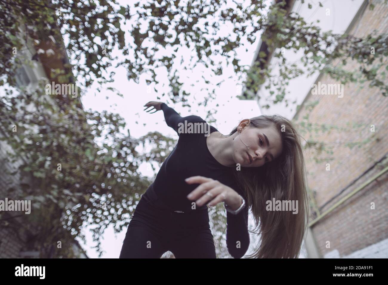 girl dancing in euphoria and sadness on the street with grapes on the ...