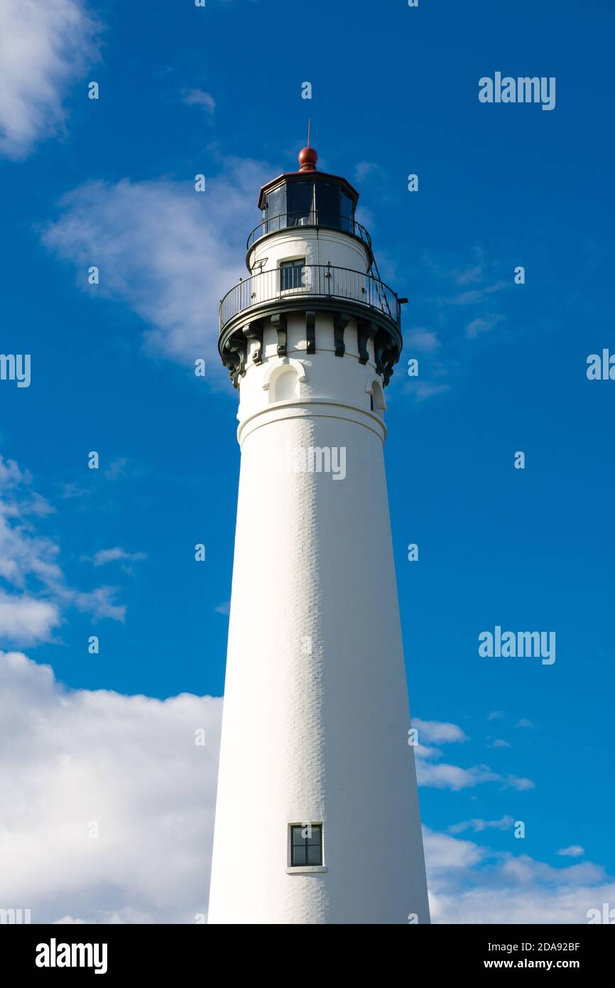 The Wind Point Lighthouse with blue skies and clouds in the background ...