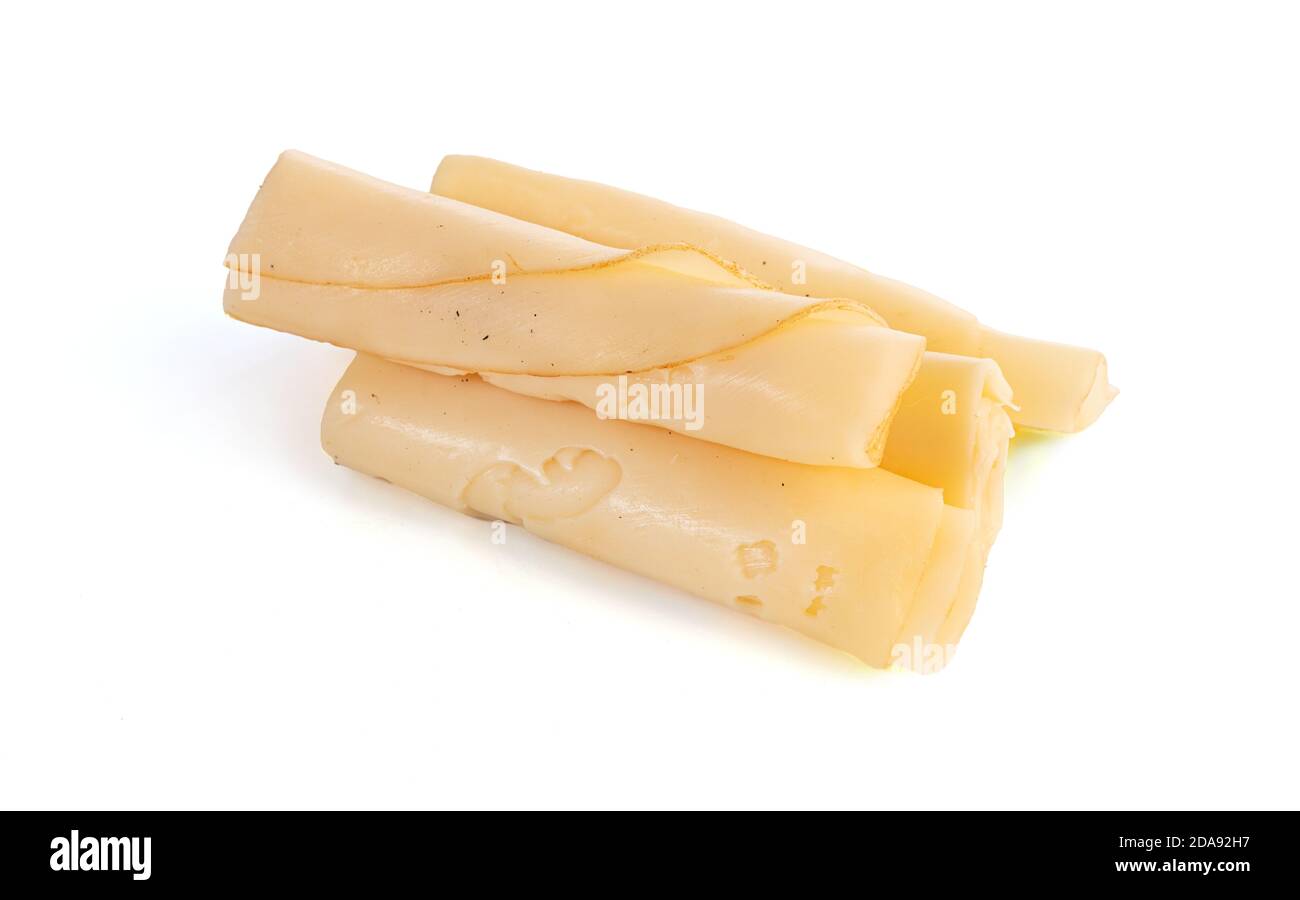 thinly sliced cow's milk cheese rolled on a white background Stock ...