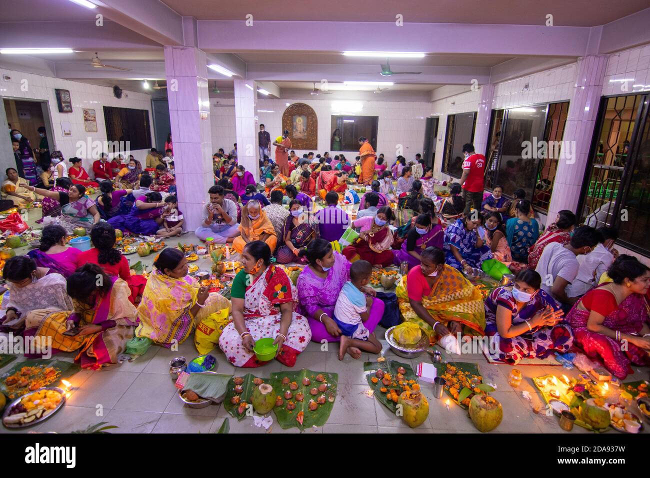 Bangladesh. 10th Nov, 2020. Hindu devotees sit with Prodip (lights) and ...