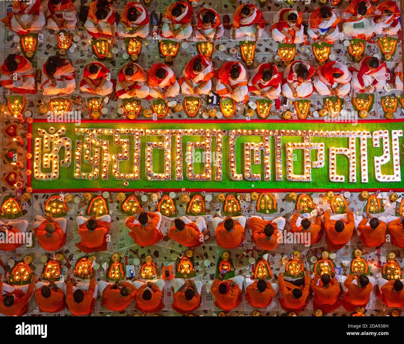 Bangladesh. 10th Nov, 2020. Hindu devotees sit with Prodip (lights) and ...