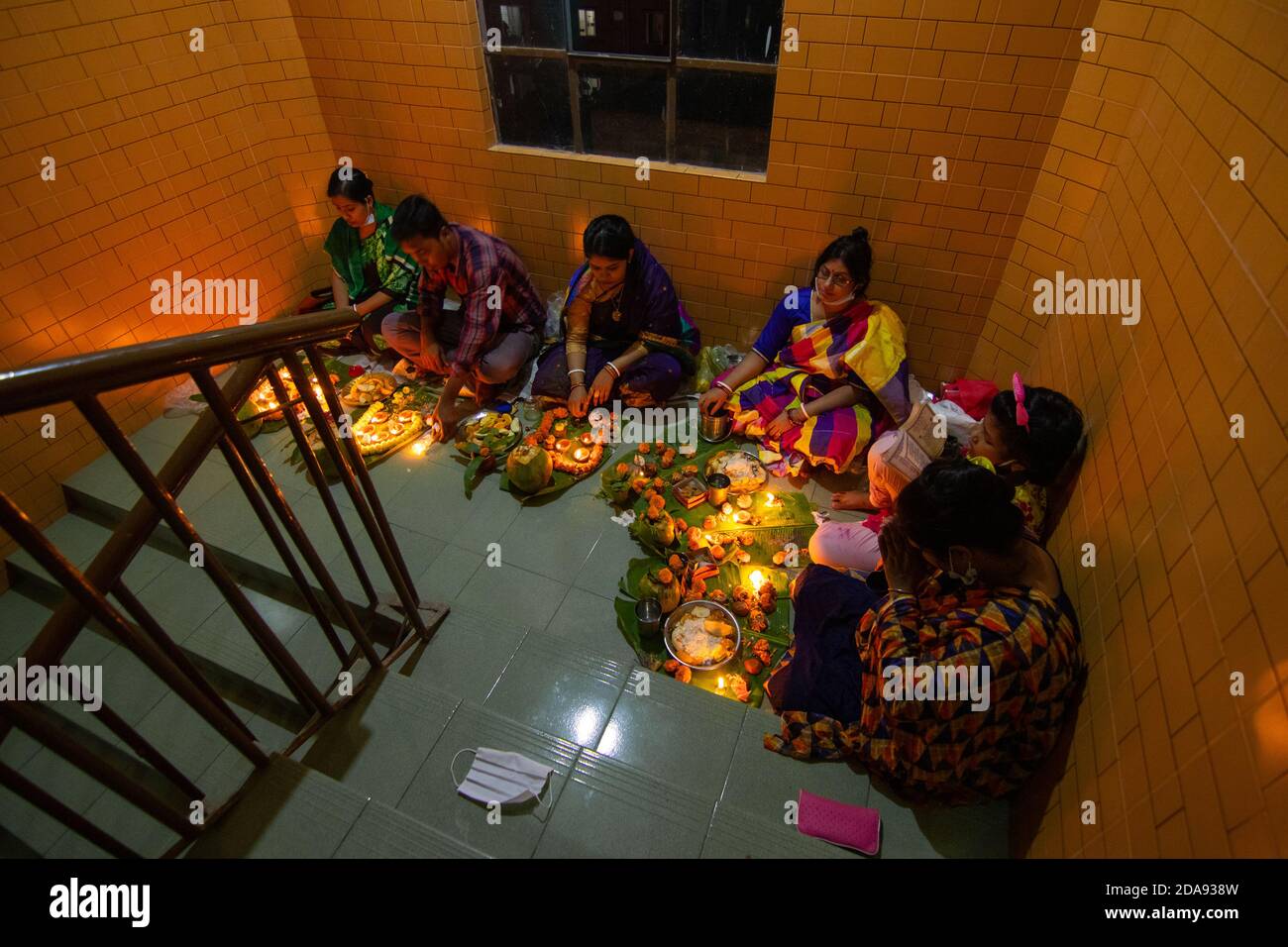 Bangladesh. 10th Nov, 2020. Hindu devotees sit with Prodip (lights) and ...