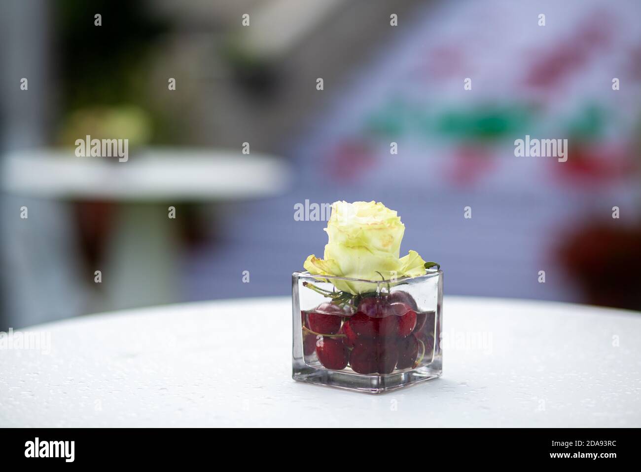 Decorative glass of cherries and a rose on a celebration Stock Photo ...