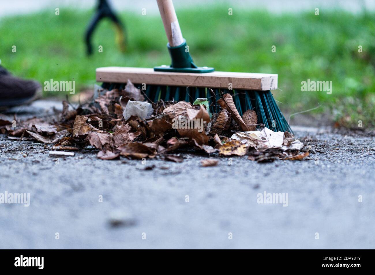 Closeup of a green street broom used in cleaning a pavement Stock Photo ...
