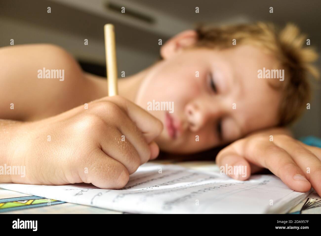 Detail of a tired and boring boy in summer while I finish his homework ...