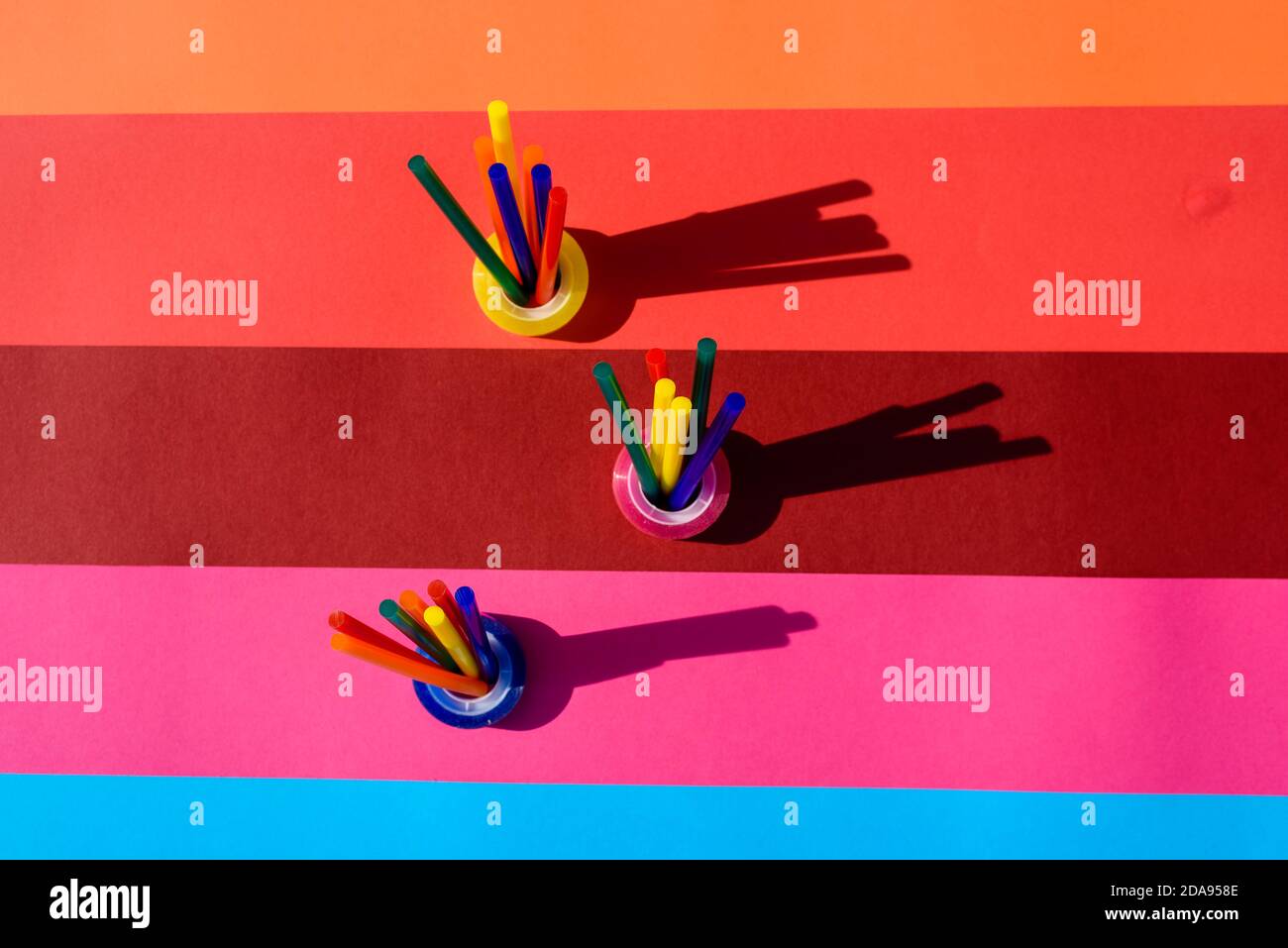 Colored background seen from above with plastic bars to use in crafts ...