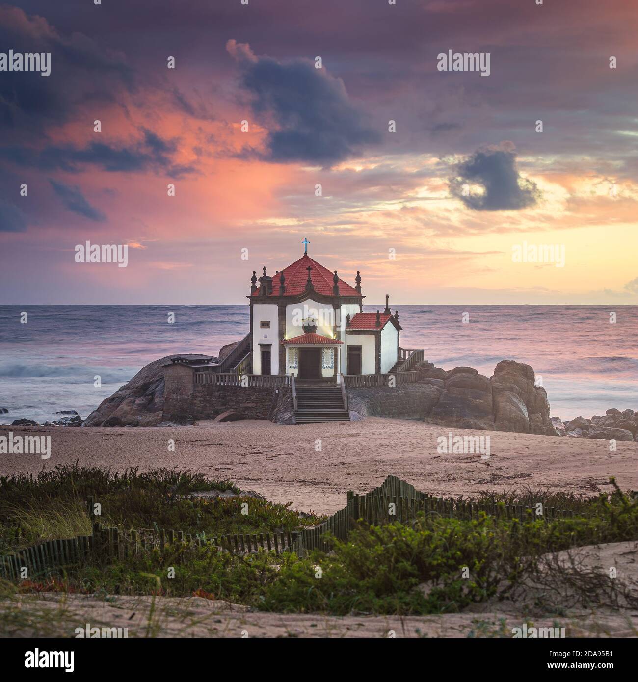 Sunset at the beach with a church in the beach (Senhor da Pedra Church ...