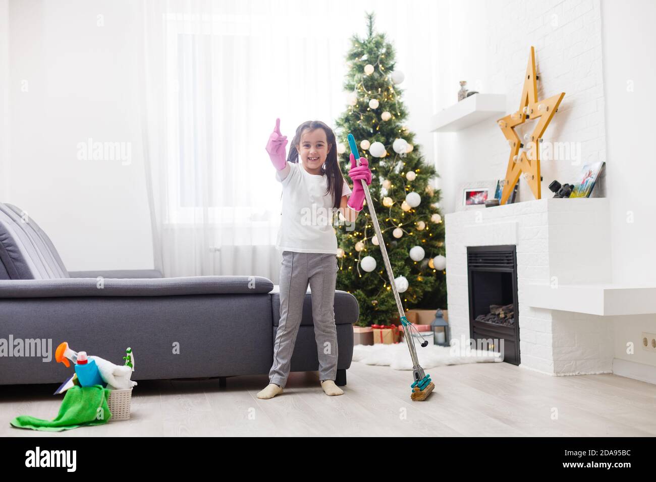 little girl cleaning the apartment before christmas Stock Photo - Alamy