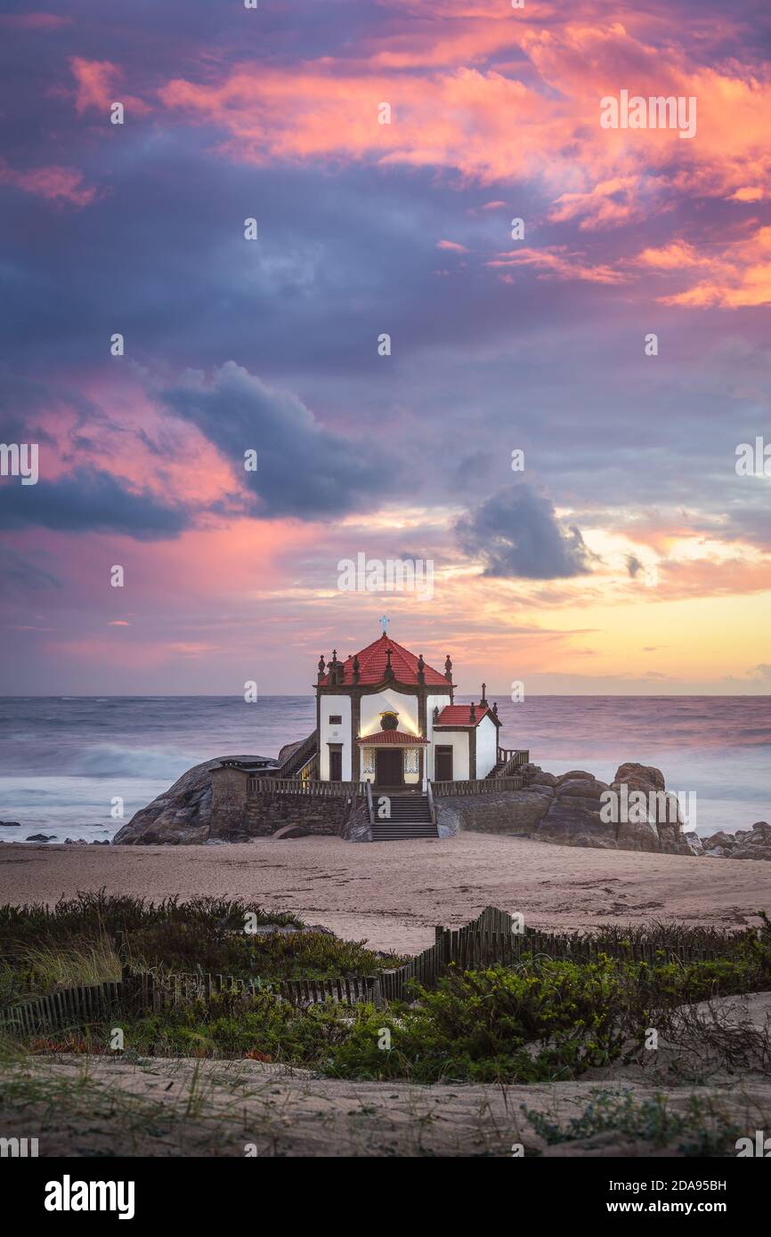 Sunset at the beach with a church in the beach (Senhor da Pedra Church ...