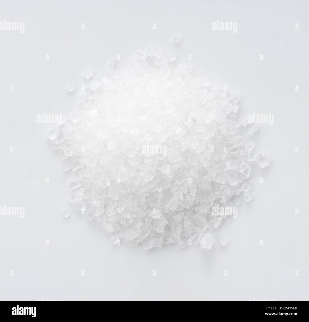 Himalayan rock salt placed on a white background. A view from above ...