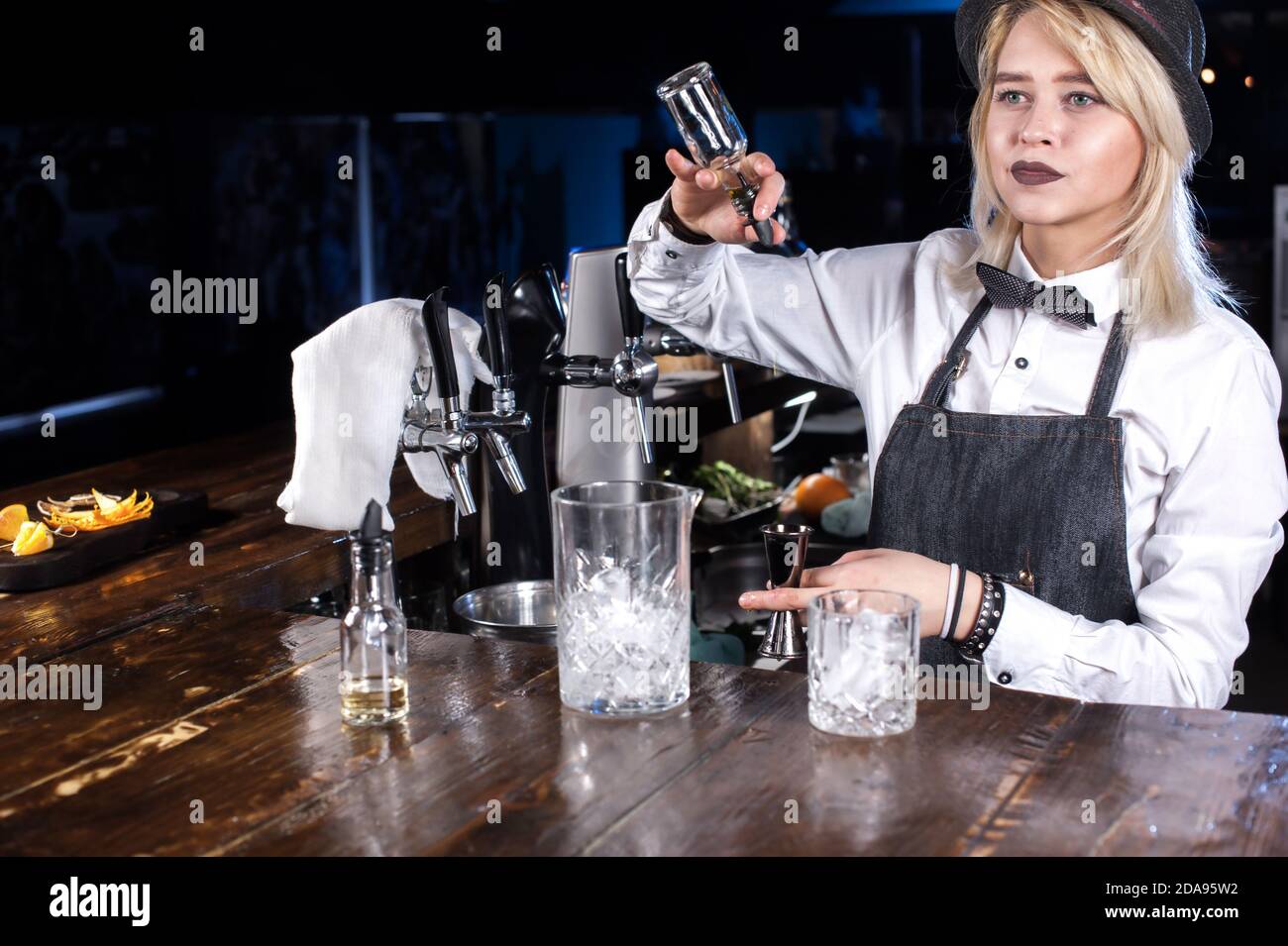 Experienced girl bartending demonstrates his professional skills in the ...