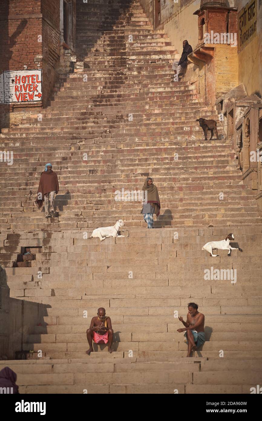 Varanasi, India, January 2008. People on the stairs of a ghat on the ...