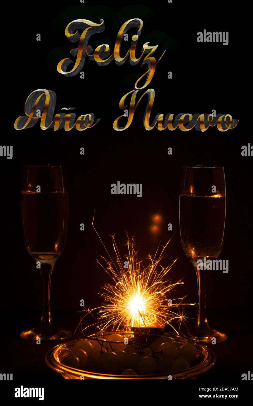 Happy New Year text in Spanish and three dimensional next to glasses of ...